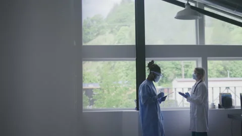 Medical Providers Stand Taking Notes | Stock Video | Pond5