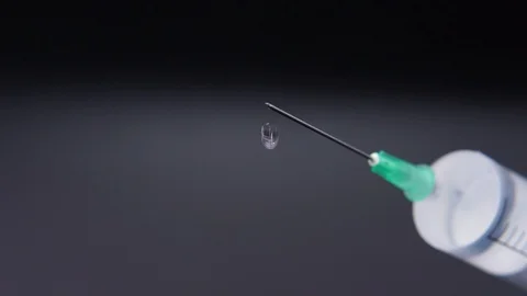 Medicine leaking from a syringe drop by ... | Stock Video | Pond5