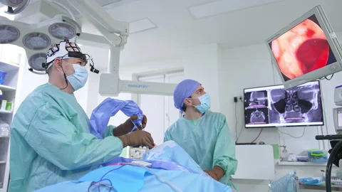 Medics look at the big screen in surgery... | Stock Video | Pond5