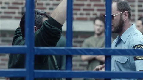 Medium shot of inmates in security check... | Stock Video | Pond5