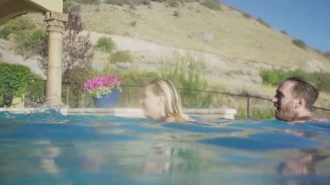 Medium shot of man dunking woman in swim... | Stock Video | Pond5