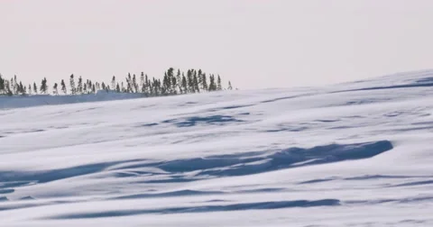 Medium shot of snow blowing across a pla... | Stock Video | Pond5