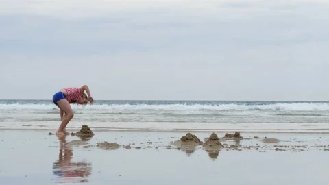 Medium shot of two boys playing on beach... | Stock Video | Pond5