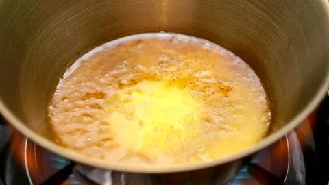 Melt the butter in the pan. | Stock Video | Pond5