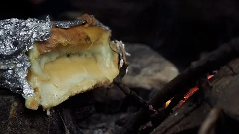 Melted cheese sandwich by fire for dinne... | Stock Video | Pond5