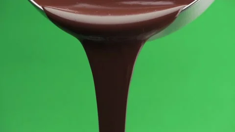 Melted chocolate pouring on a green scre... | Stock Video | Pond5