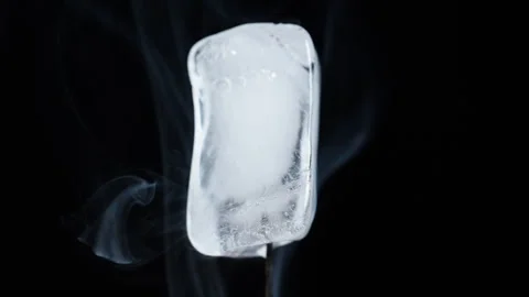 Melting ice cube with smoke on a black b... | Stock Video | Pond5