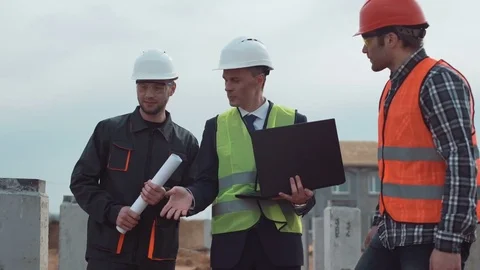 Men on building site discussing the blue... | Stock Video | Pond5