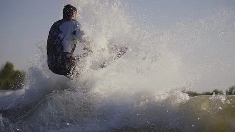 men ride a jetski on a river | Stock Video | Pond5