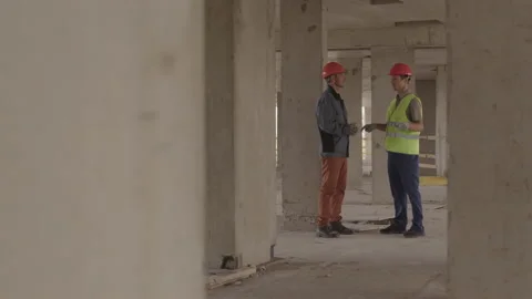 Men Talking Inside Building Frame | Stock Video | Pond5