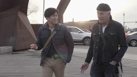 Men talking, walking on sunny city sidew... | Stock Video | Pond5