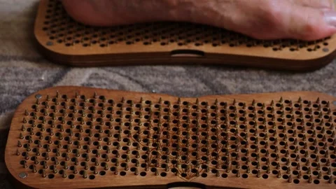 Men's feet stand on the sadhu's board | Stock Video | Pond5