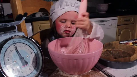 Messy girl with chef uniform using a whi... | Stock Video | Pond5