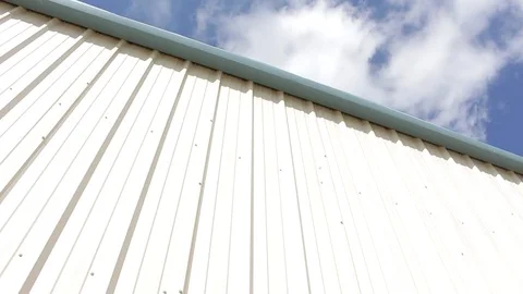 Metal building side with blue sky | Stock Video | Pond5