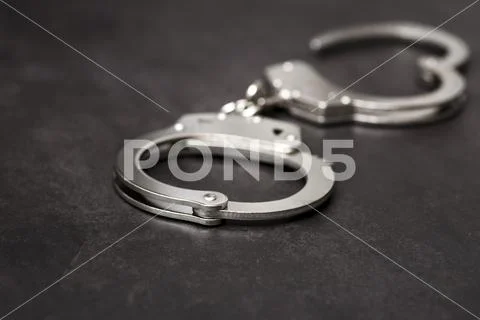 The metal handcuffs on black background. Handcuff or shackle. Police ...