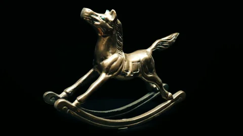 Metal rocking horse of golden color rota... | Stock Video | Pond5
