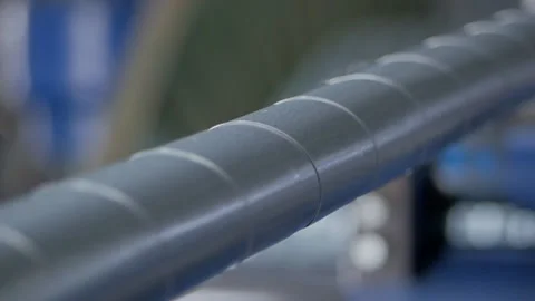 A metal-wrapped cable moving along a con... | Stock Video | Pond5