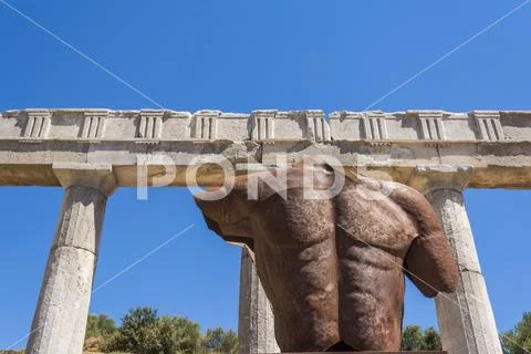 Photograph: Metallic headless statue in the ancient Greek city of ...