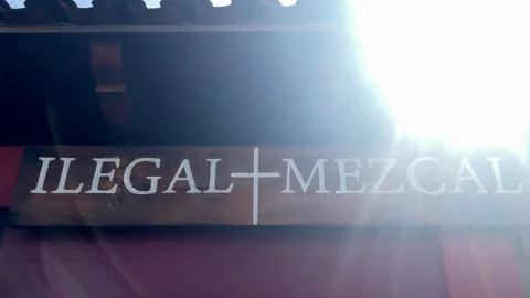 mezcal illegal sign on wooden with light... | Stock Video | Pond5