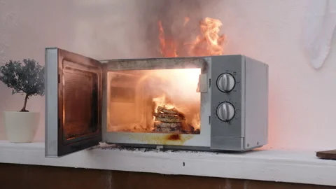 Microwave oven smokes and explodes in bu... | Stock Video | Pond5