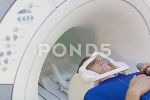 Photograph: Mid adult male patient in MRI scanner #201555192