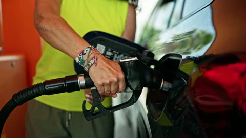 Middle age hispanic woman putting gas in... | Stock Video | Pond5