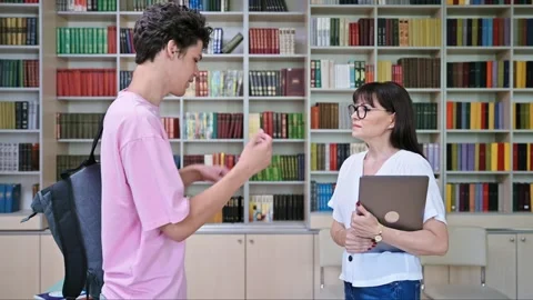 Middle-aged female teacher talking to ma... | Stock Video | Pond5