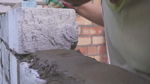 middle-aged man builds a house for himse... | Stock Video | Pond5