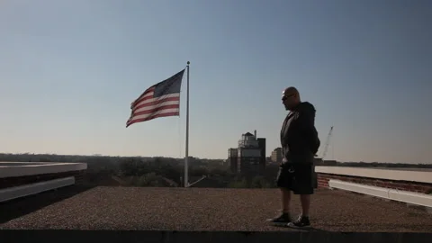 Middle-aged man walking across rooftop n... | Stock Video | Pond5