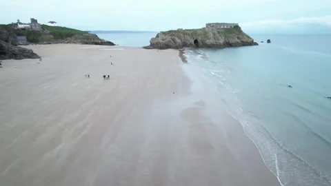 Mild waves washing sand beach, buildings... | Stock Video | Pond5