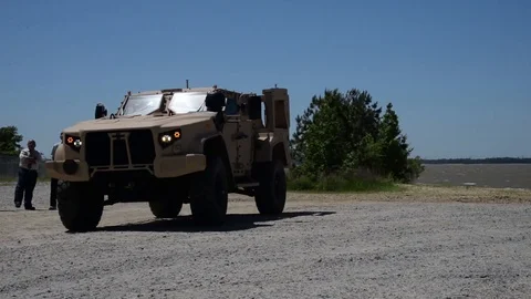 Military humvee driving away from soldie... | Stock Video | Pond5
