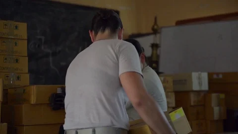 Military personnel stack boxes at outrea... | Stock Video | Pond5