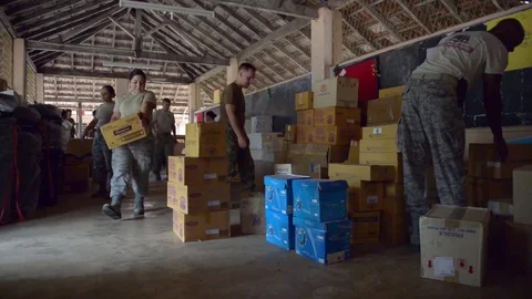 Military personnel stacking boxes at out... | Stock Video | Pond5