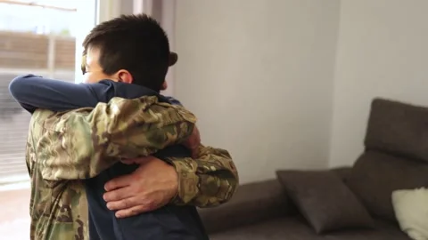 Military soldier father hugging his son ... | Stock Video | Pond5