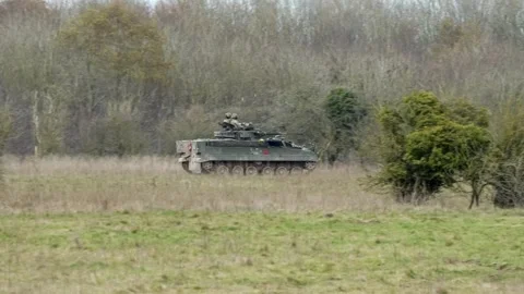 Military tank driving in the green field... | Stock Video | Pond5