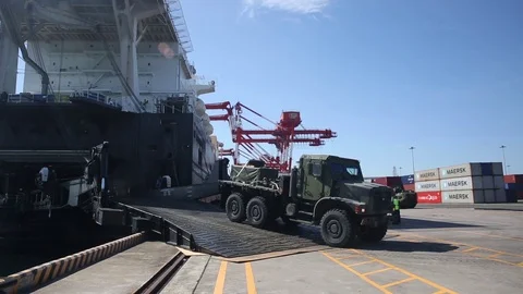 Military truck reversing up ramp of USNS... | Stock Video | Pond5