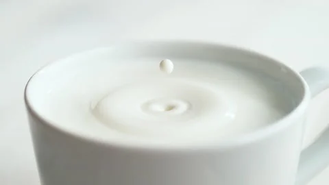 Milk Drop Falling into the Mug with Crea... | Stock Video | Pond5