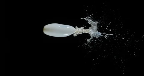 Milk Exploding and Splashing on Black Ba... | Stock Video | Pond5