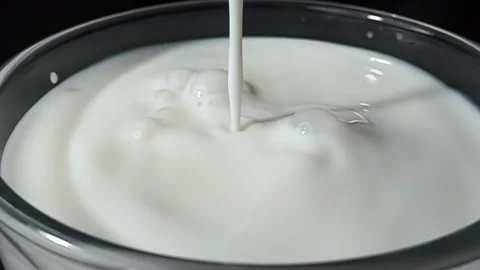 Milk pouring into glass in slow motion. | Stock Video | Pond5
