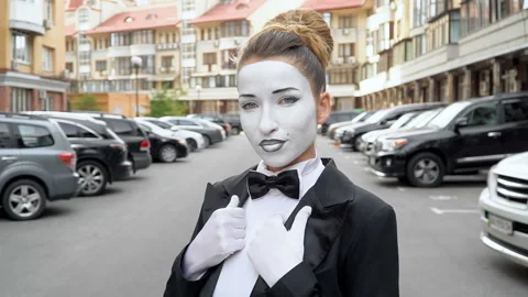 A mime girl in a black dress coat poses ... | Stock Video | Pond5
