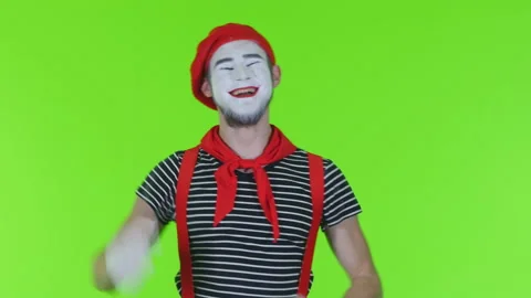 Mime man takes mask on green background | Stock Video | Pond5