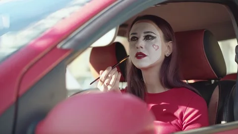 Mime paints her lips with red lipstick w... | Stock Video | Pond5