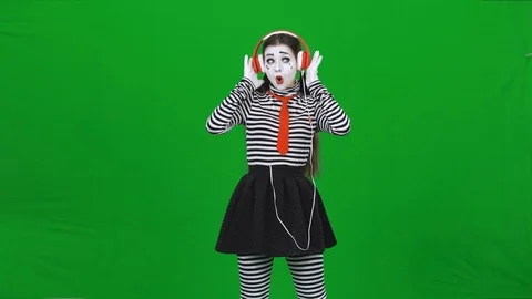Mime woman listening to the music throug... | Stock Video | Pond5