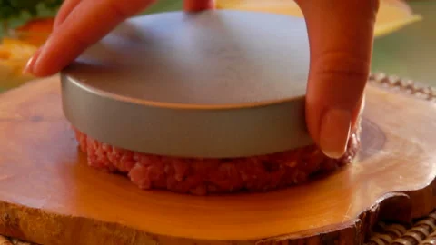 Minced meat is pressed into a beef burge... | Stock Video | Pond5