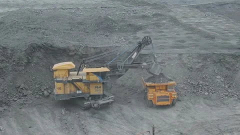 Mine excavator loading coal into dump tr... | Stock Video | Pond5