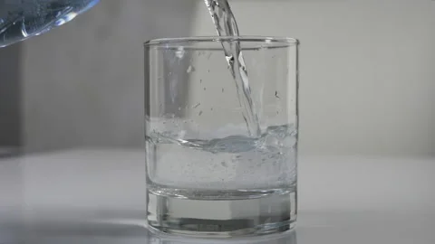 Mineral water flow into a glass beaker o... | Stock Video | Pond5
