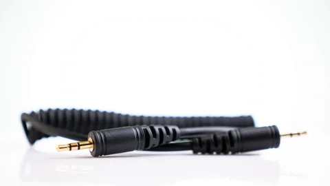 Mini jack audio cable rotating on a whit... | Stock Video | Pond5
