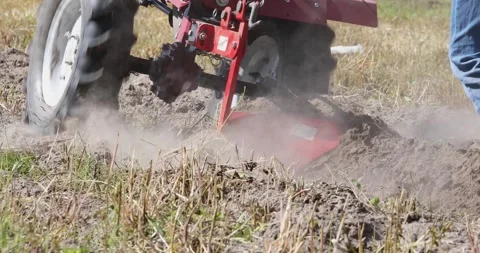 Minitractor tillerblock plows the ground... | Stock Video | Pond5