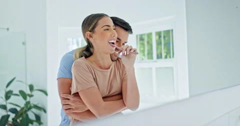 Mirror, love and couple hug while brushi... | Stock Video | Pond5