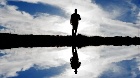 mirror water reflection of man walking o... | Stock Video | Pond5